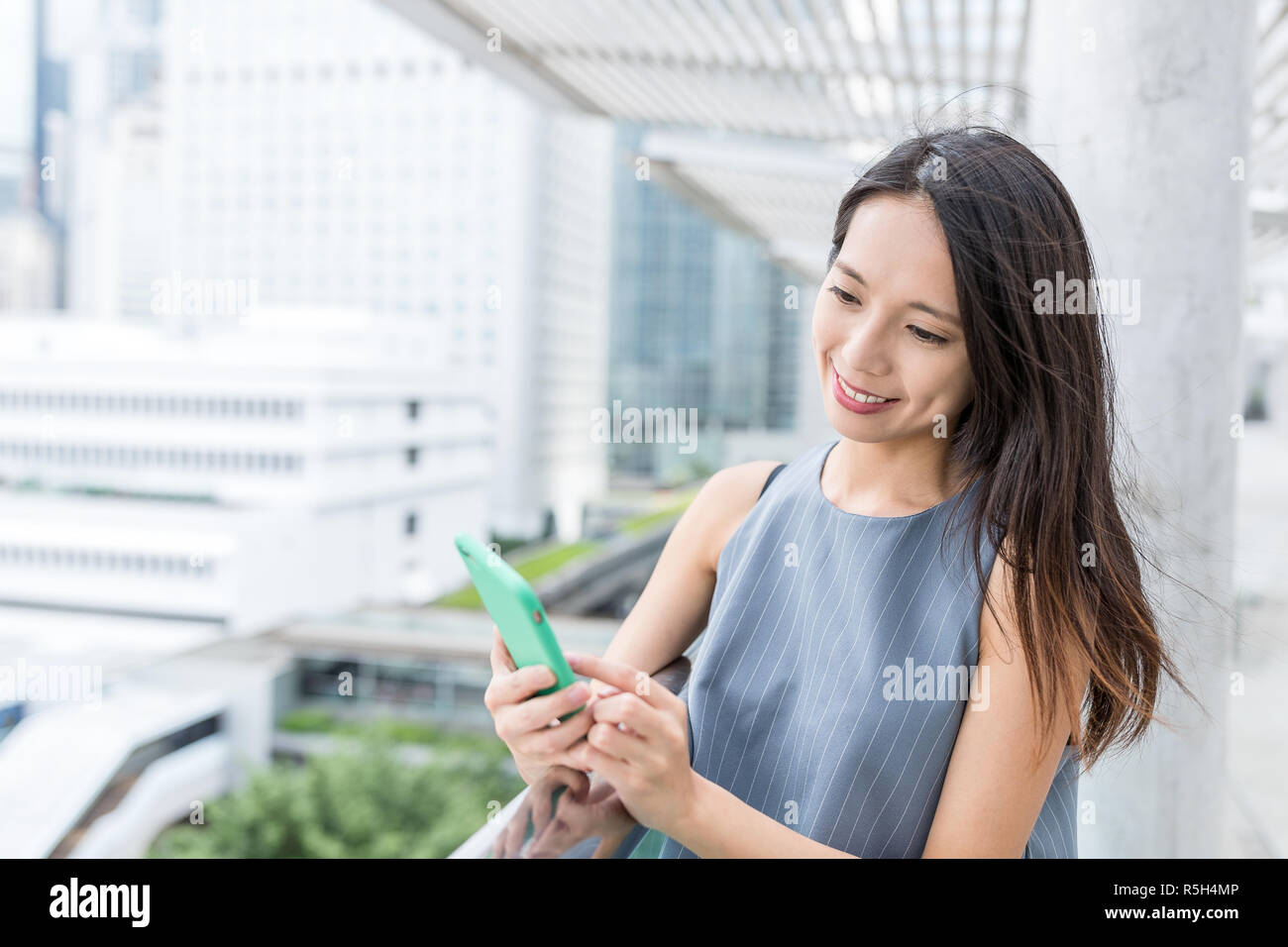 Business woman working on cellphone Stock Photo - Alamy