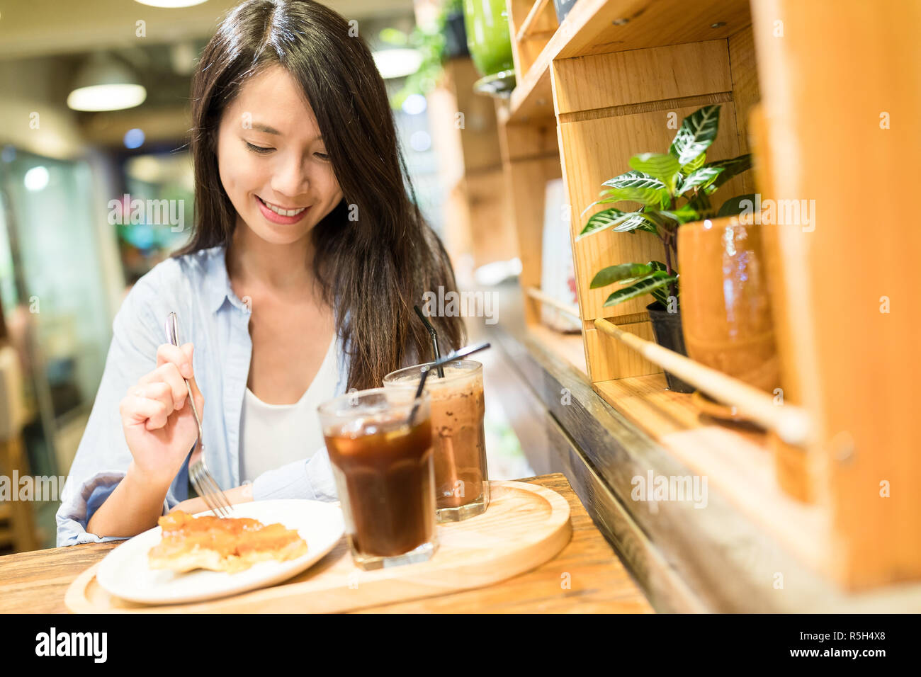 Woman enjoy her food in restaurant Stock Photo - Alamy