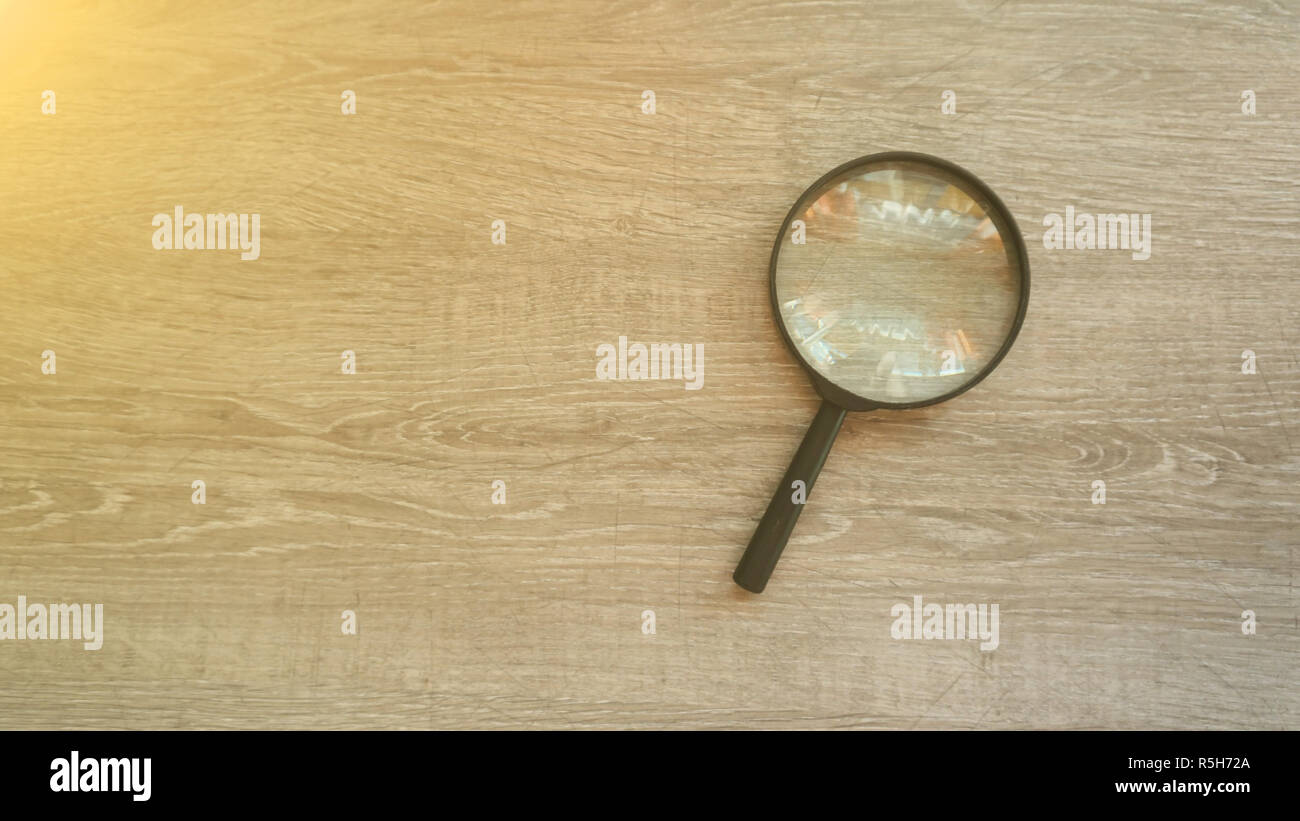 magnifying glass on the grey laminate background. Sun effect Stock ...