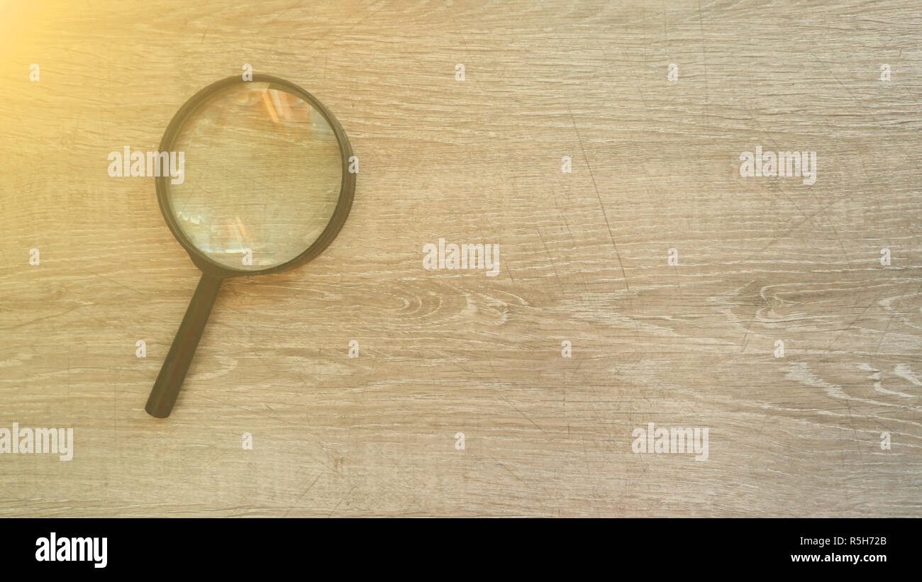magnifying glass on the grey laminate background. Sun effect Stock ...