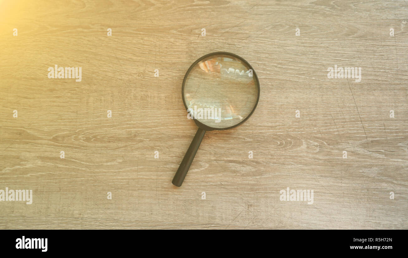 magnifying glass on the grey laminate background. Sun effect Stock ...