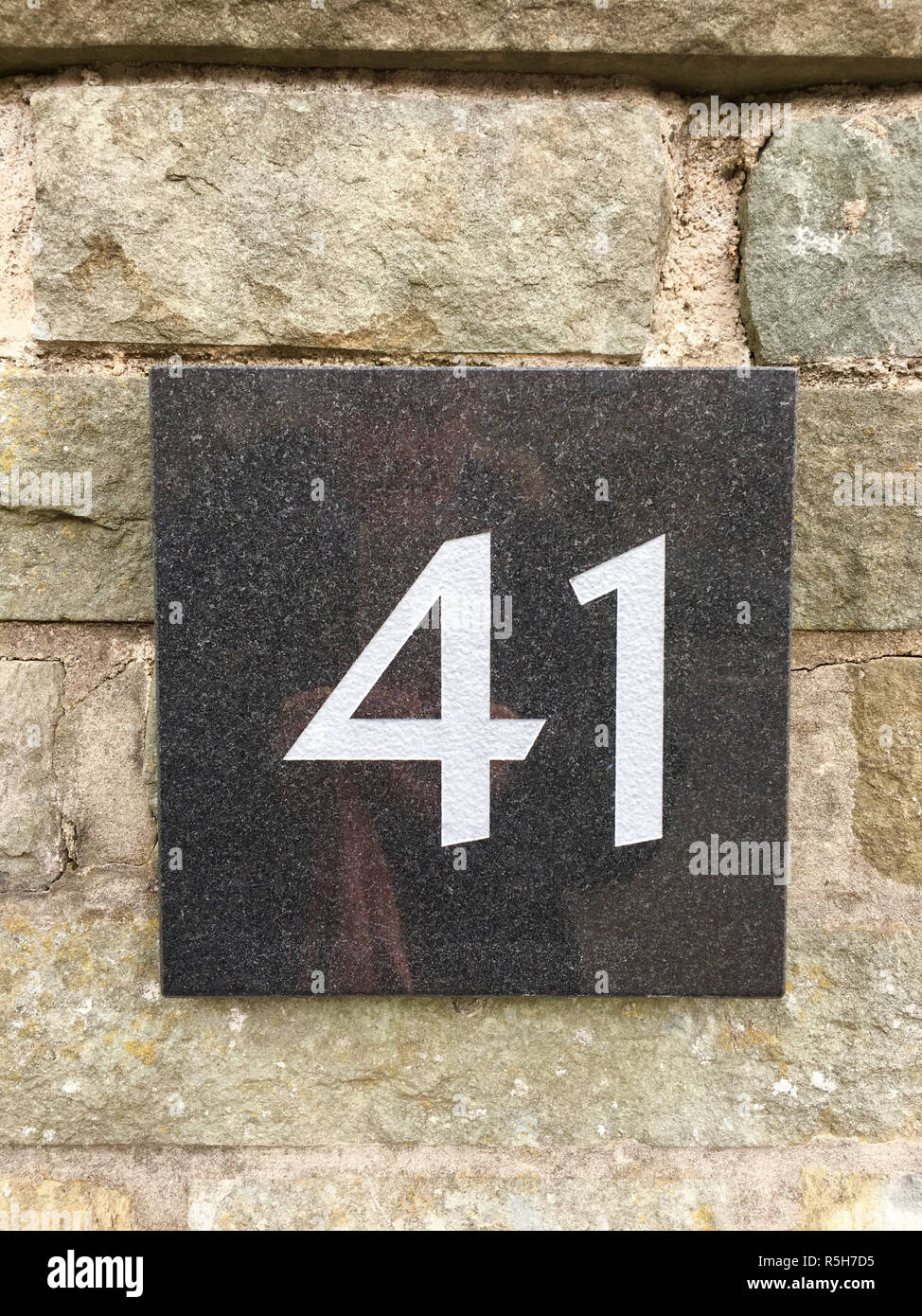 house number 41 on a granite slab on a brick wall Stock Photo - Alamy