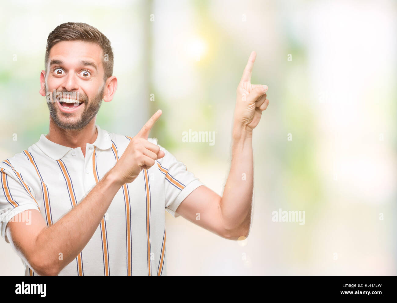 Young handsome man over isolated background smiling and looking at the ...