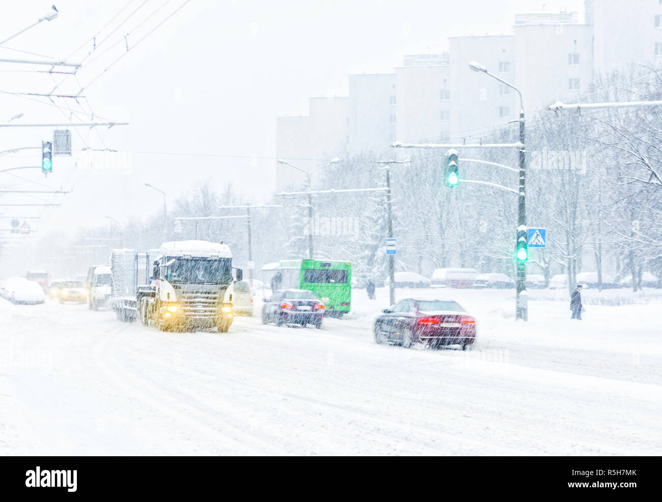 Pedestrian crossing during a snow storm. Silhouettes of people crossing ...