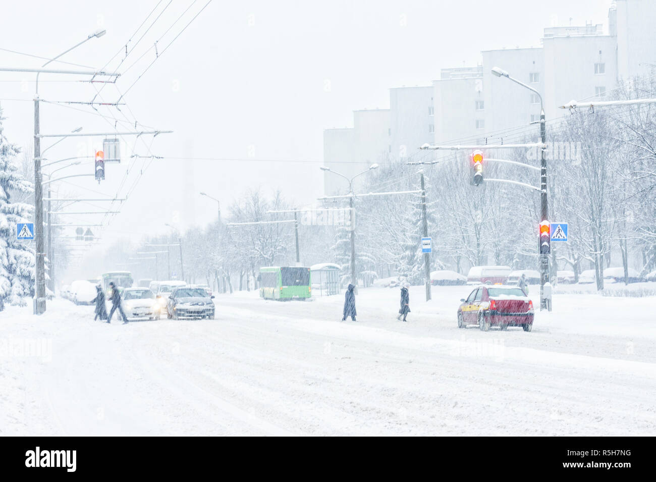 Pedestrian crossing during a snow storm. Silhouettes of people crossing ...