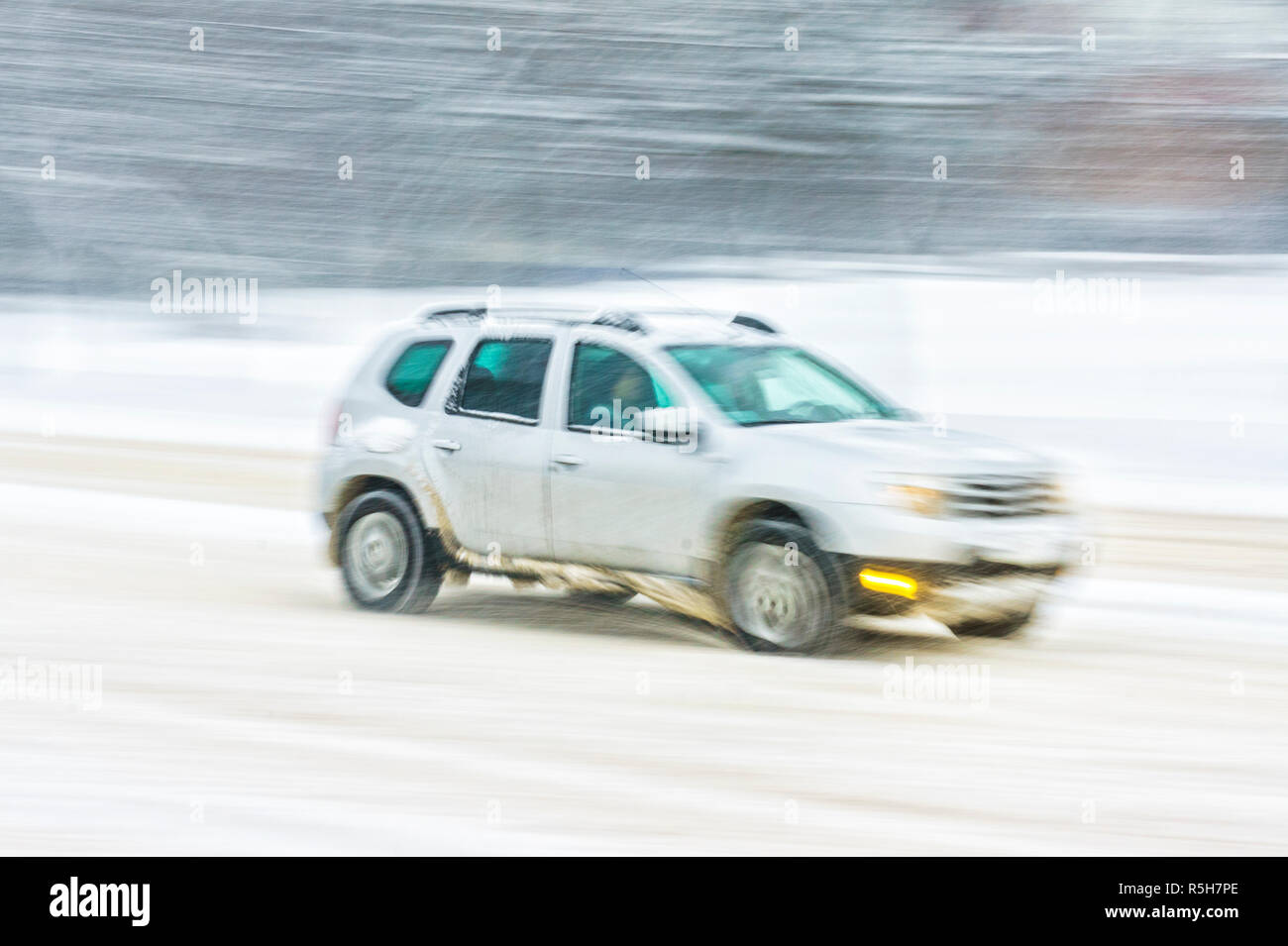 Driving in snow. Motion in blur car in heavy snowfall in city road ...