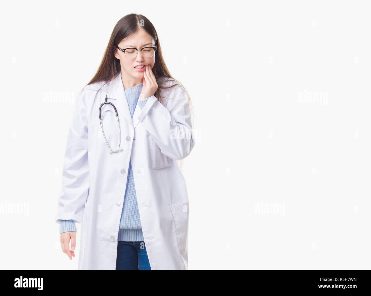 Young Chinese doctor woman over isolated background touching mouth with ...