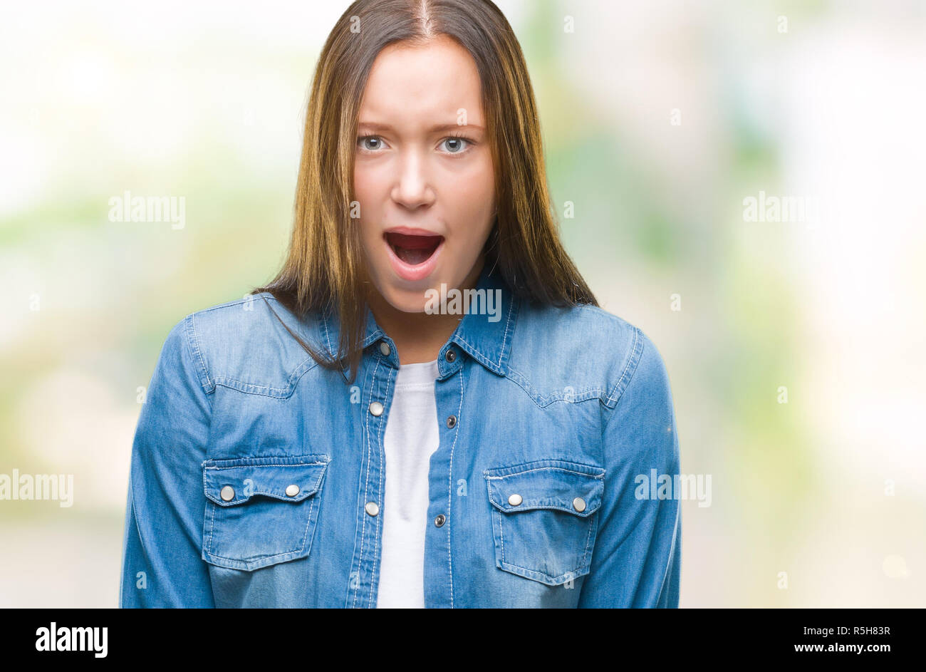 Young caucasian beautiful woman over isolated background afraid and ...
