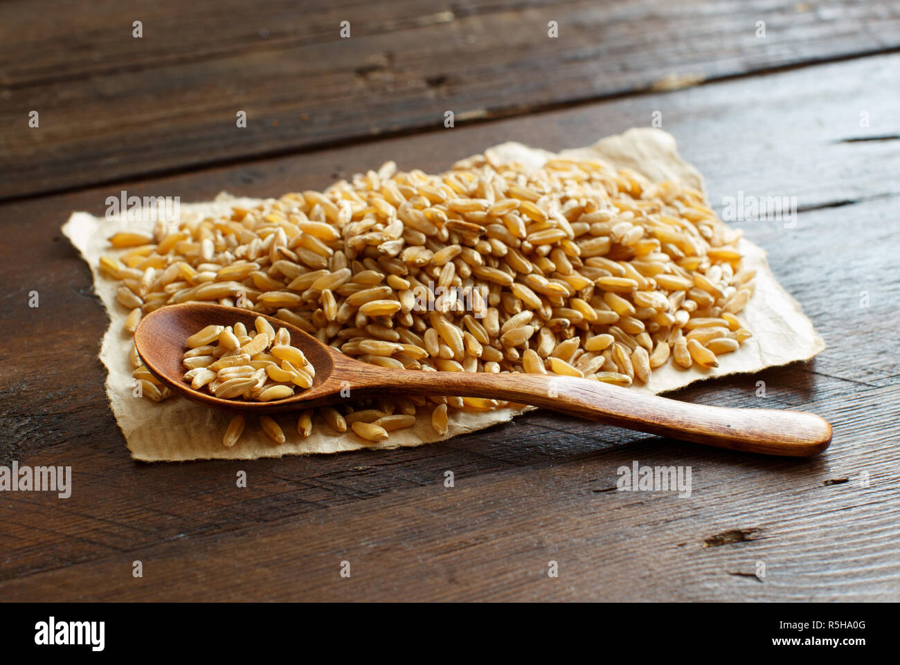 Pile of Kamut grain on wooden background Stock Photo - Alamy