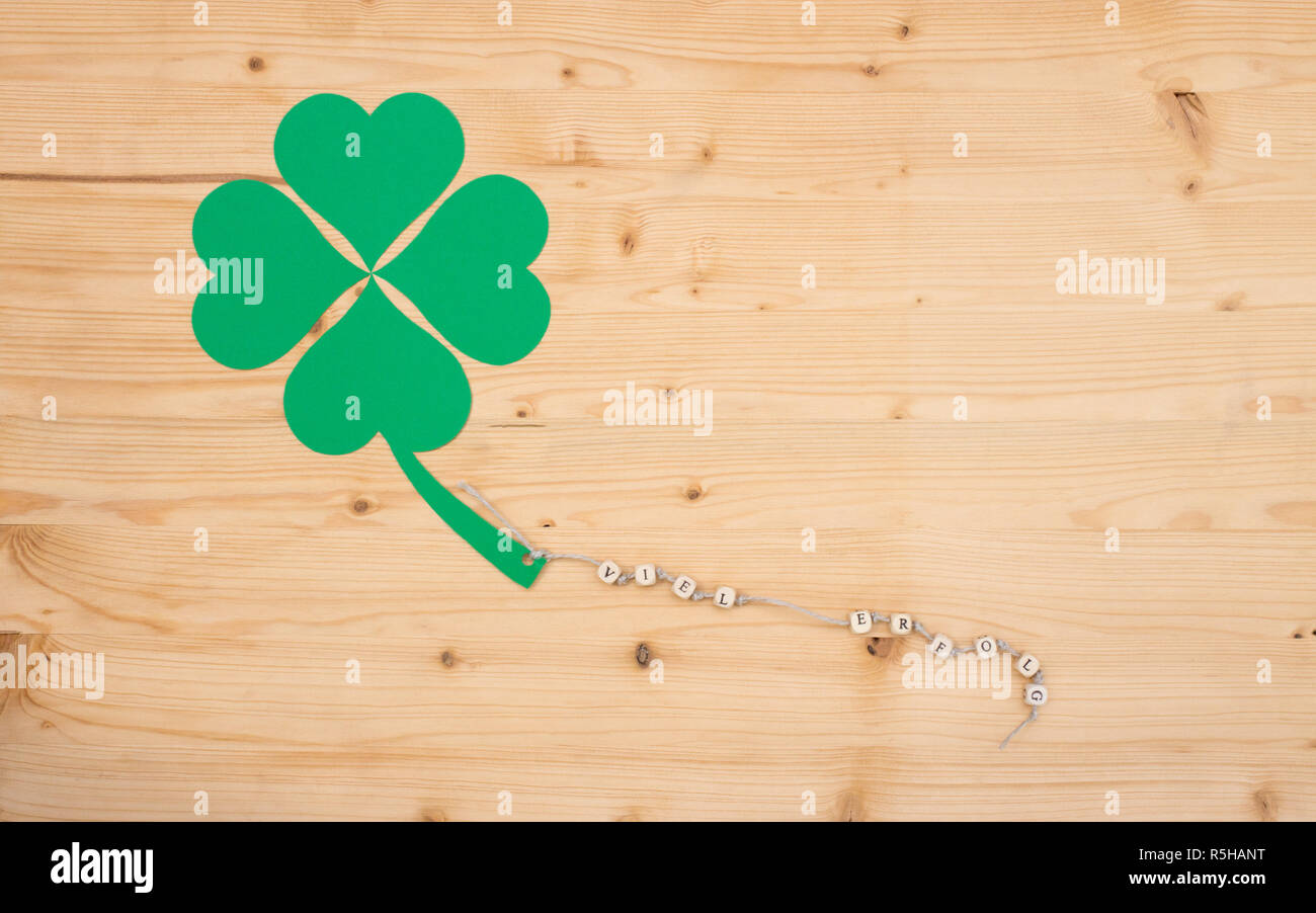 the words good luck and a shamrock on a drawstring on wood Stock Photo ...