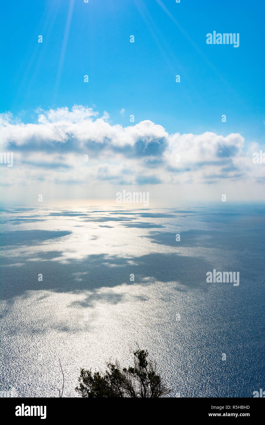 Clouds reflecting on sea water Stock Photo - Alamy