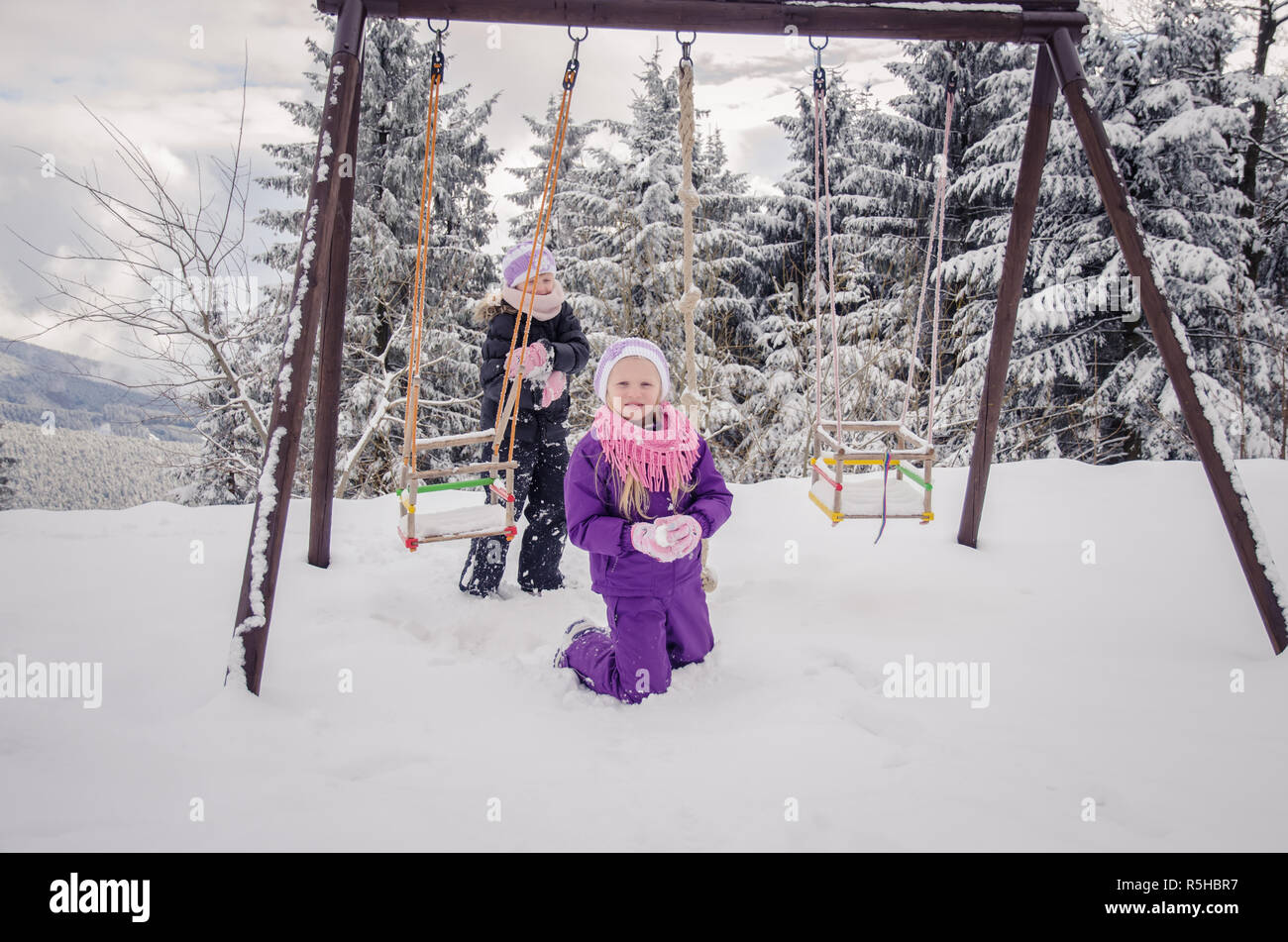 swing and children in playground in winter time Stock Photo - Alamy