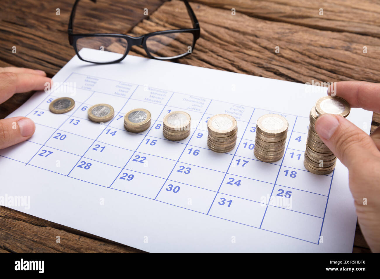 Man stacking coins table hi-res stock photography and images - Alamy
