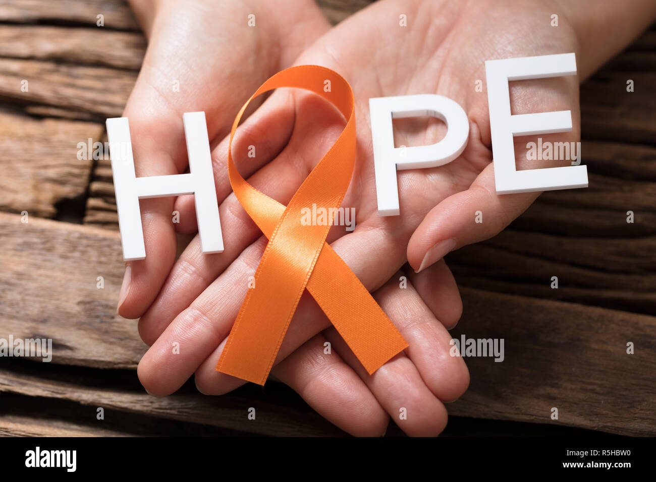 Hand Showing Ribbon With Hope Text Stock Photo - Alamy