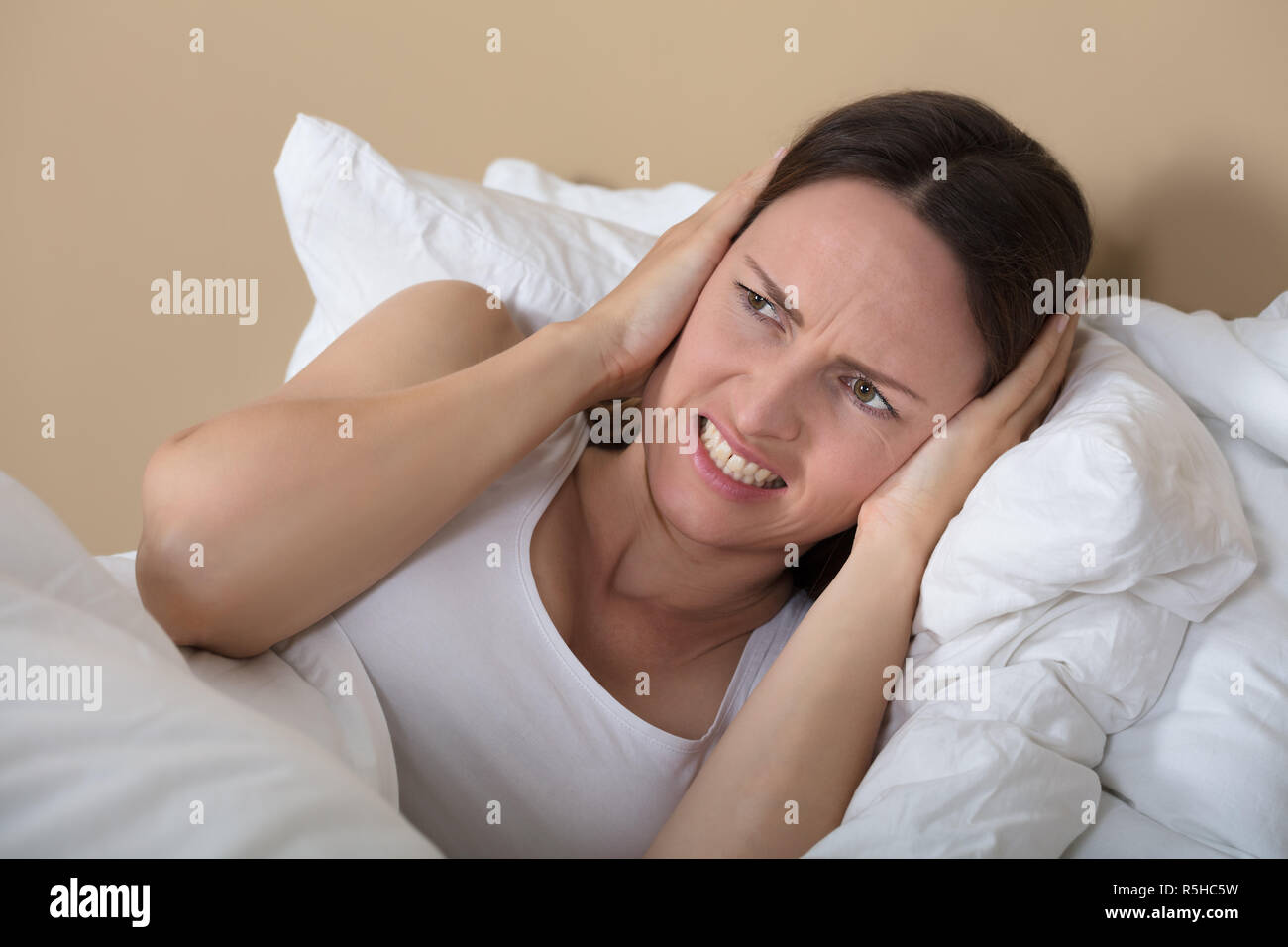 Woman Covering Ears To Shut Out Noise Stock Photo - Alamy Woman Covering Ears To Shut Out Noise Stock Photo - Alamy