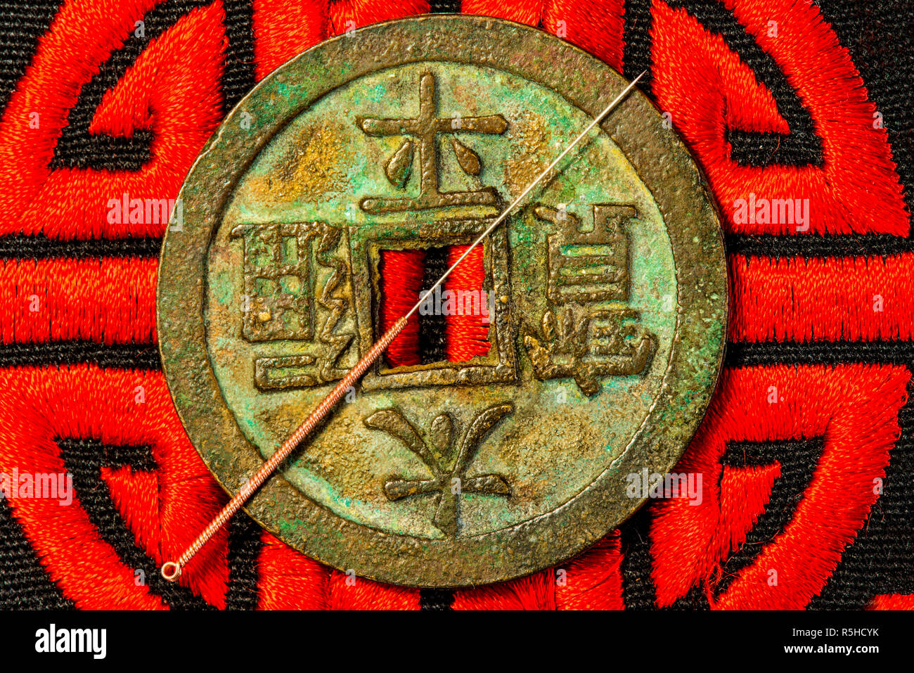 acupuncture needles on antique chinese coin Stock Photo - Alamy
