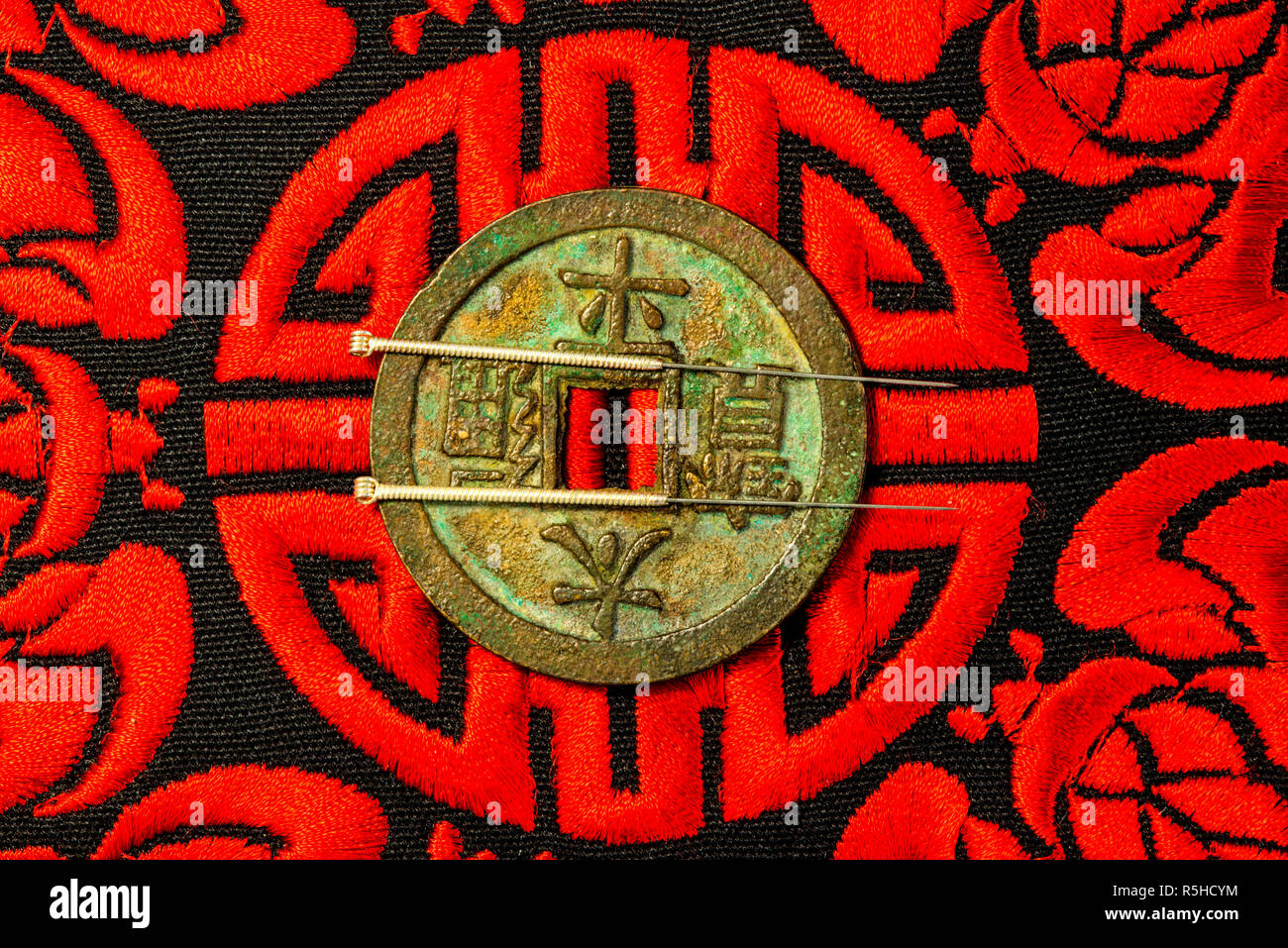 acupuncture needles on antique chinese coin Stock Photo - Alamy