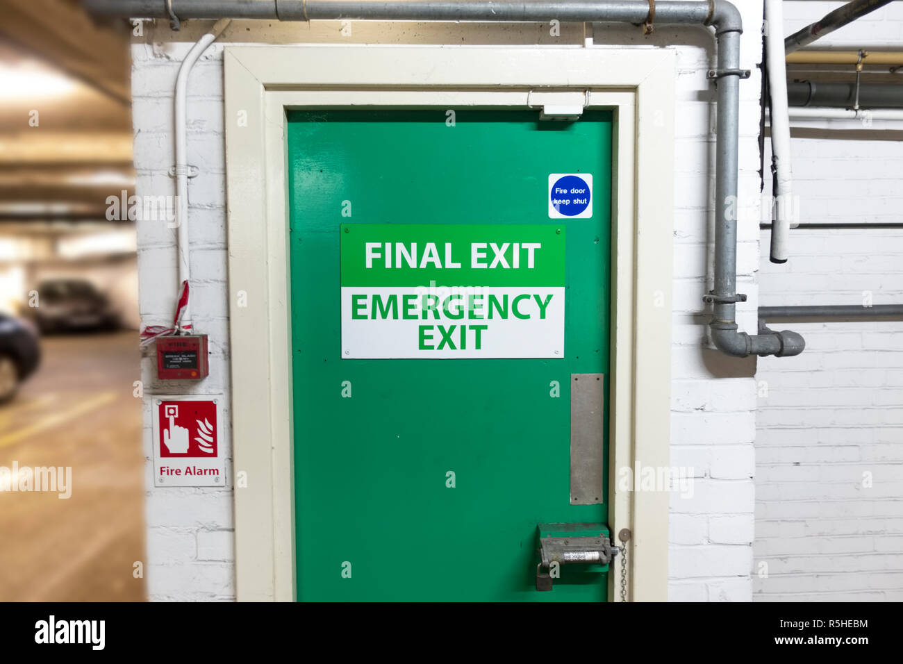 final exit emergency green door car park Stock Photo - Alamy