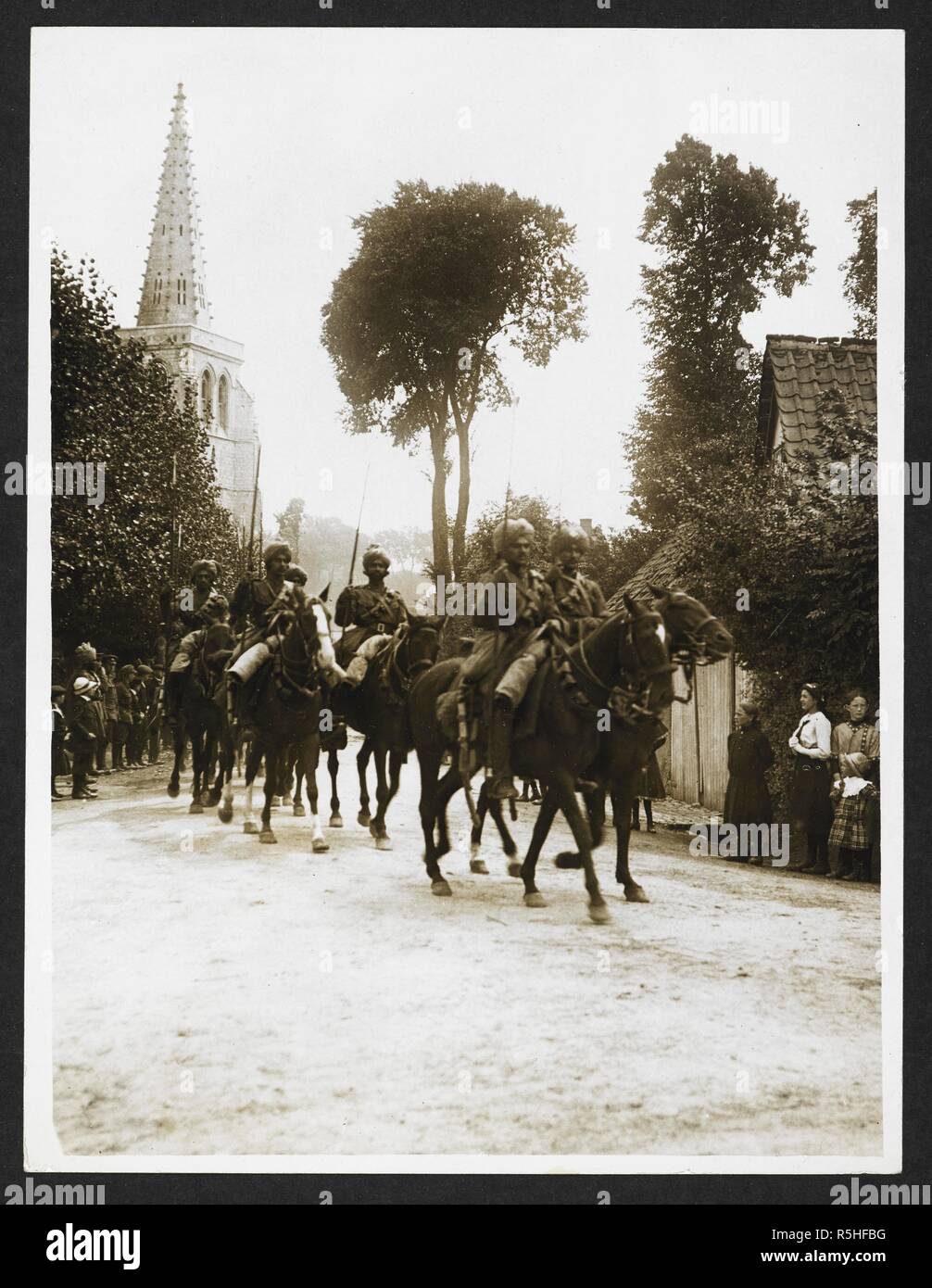 Indian cavalry marching through a French village [EstrÃ©e Blanche ...