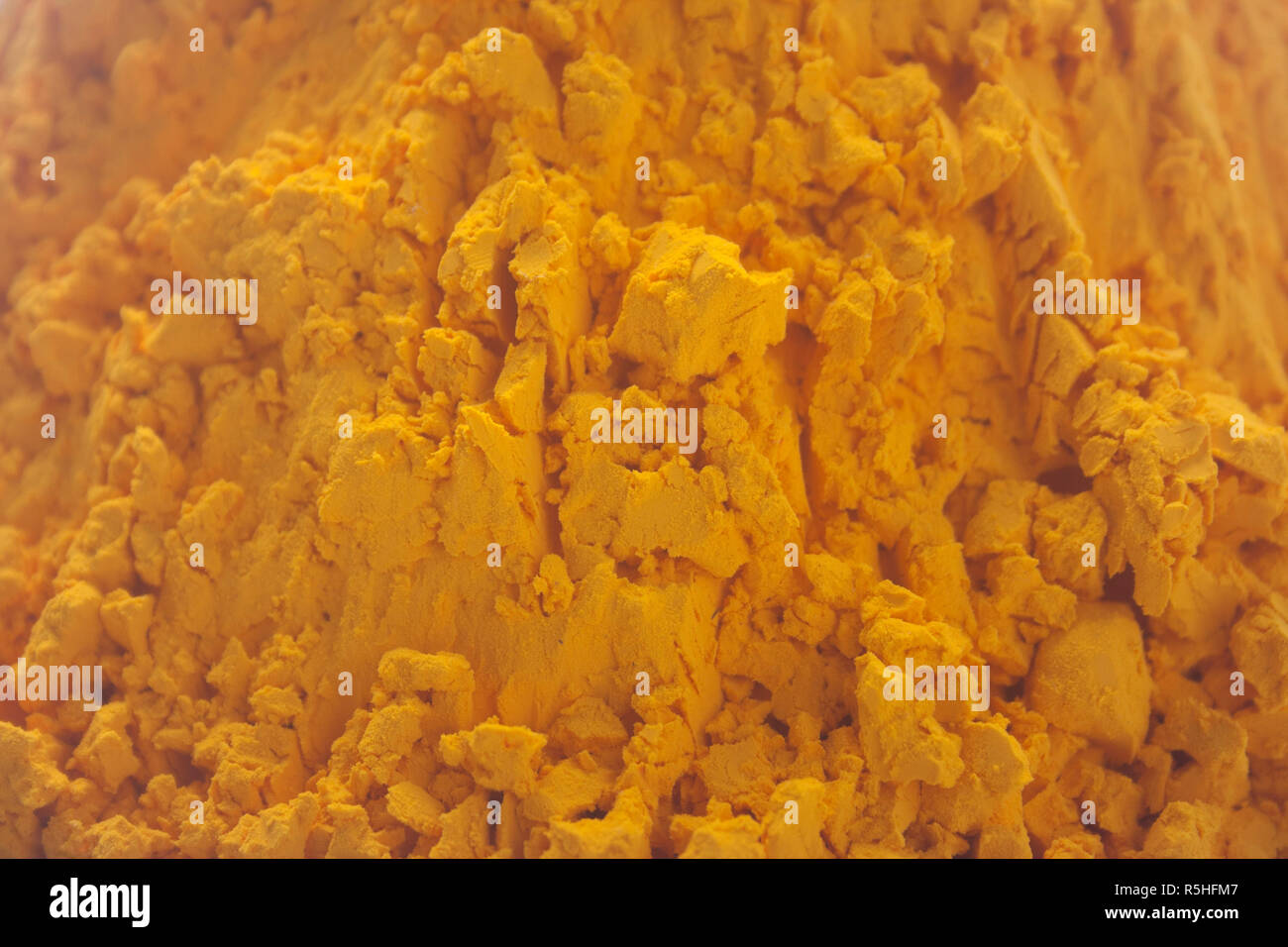 Indian Holi festival yellow colour in bowl Stock Photo - Alamy
