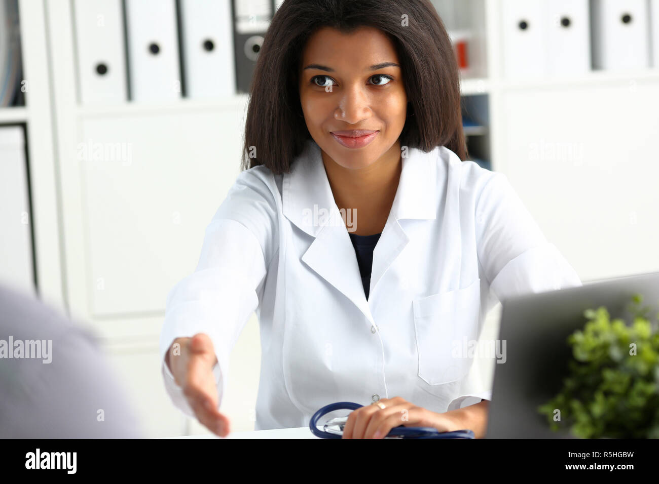 Doctor shake hand as hello with patient Stock Photo - Alamy