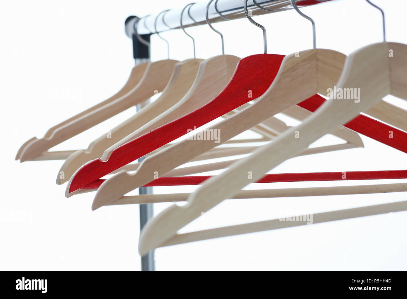 Red and wooden hanger hanging on metal Stock Photo - Alamy
