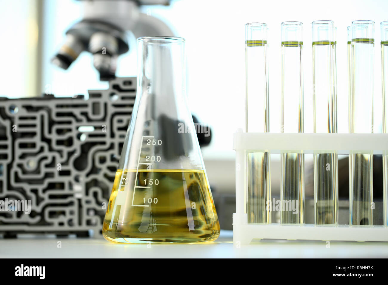 Test tube chemistry flask against background Stock Photo - Alamy