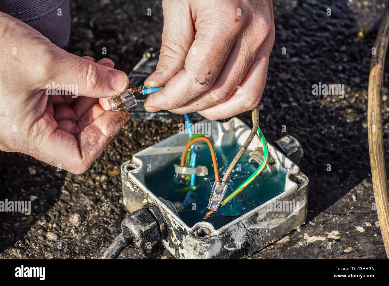 hands of electrician with terminal forbox and screwdriver tighten up ...