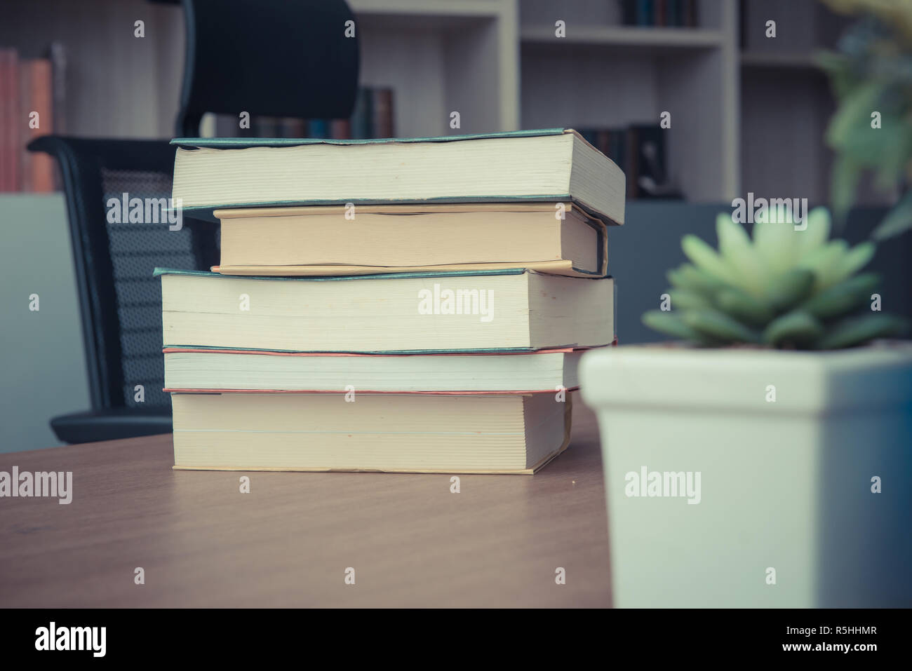 Pack of Book stack on table in working room at office, Vintage style ...