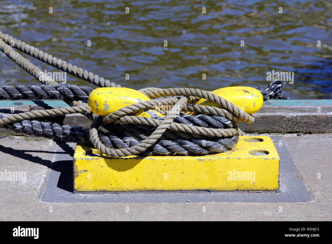 yellow harbor bollard Stock Photo - Alamy