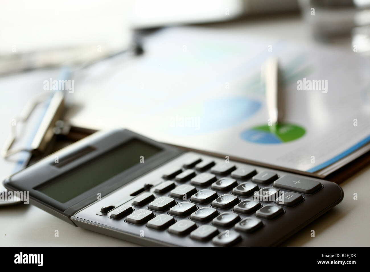 Silver calculator with gray keyboard is lying Stock Photo - Alamy
