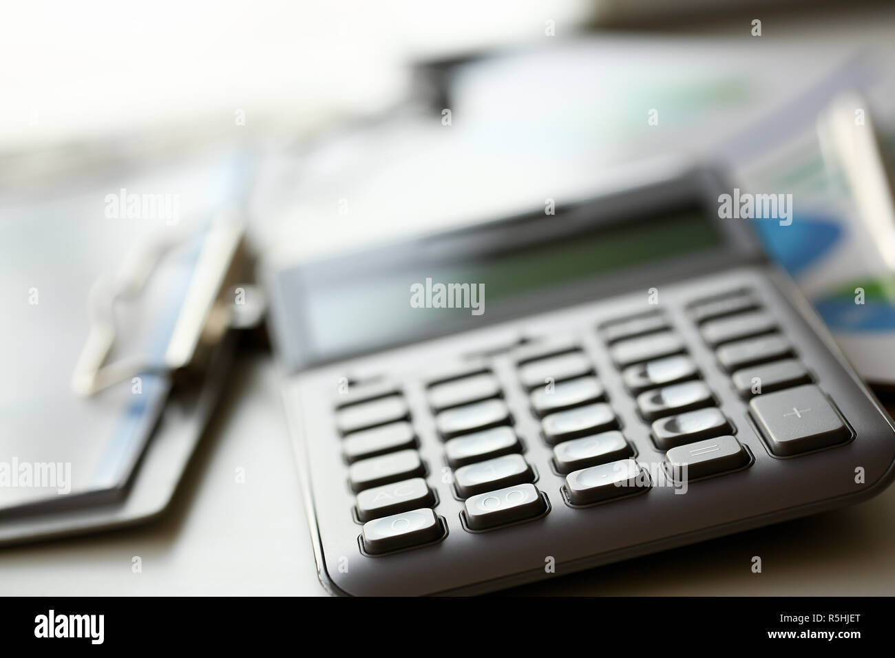 Silver calculator with gray keyboard is lying Stock Photo - Alamy