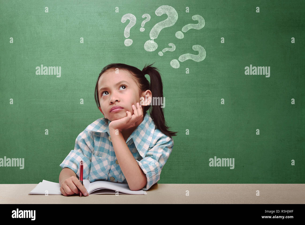Funny expression asian little girl thinking something Stock Photo - Alamy