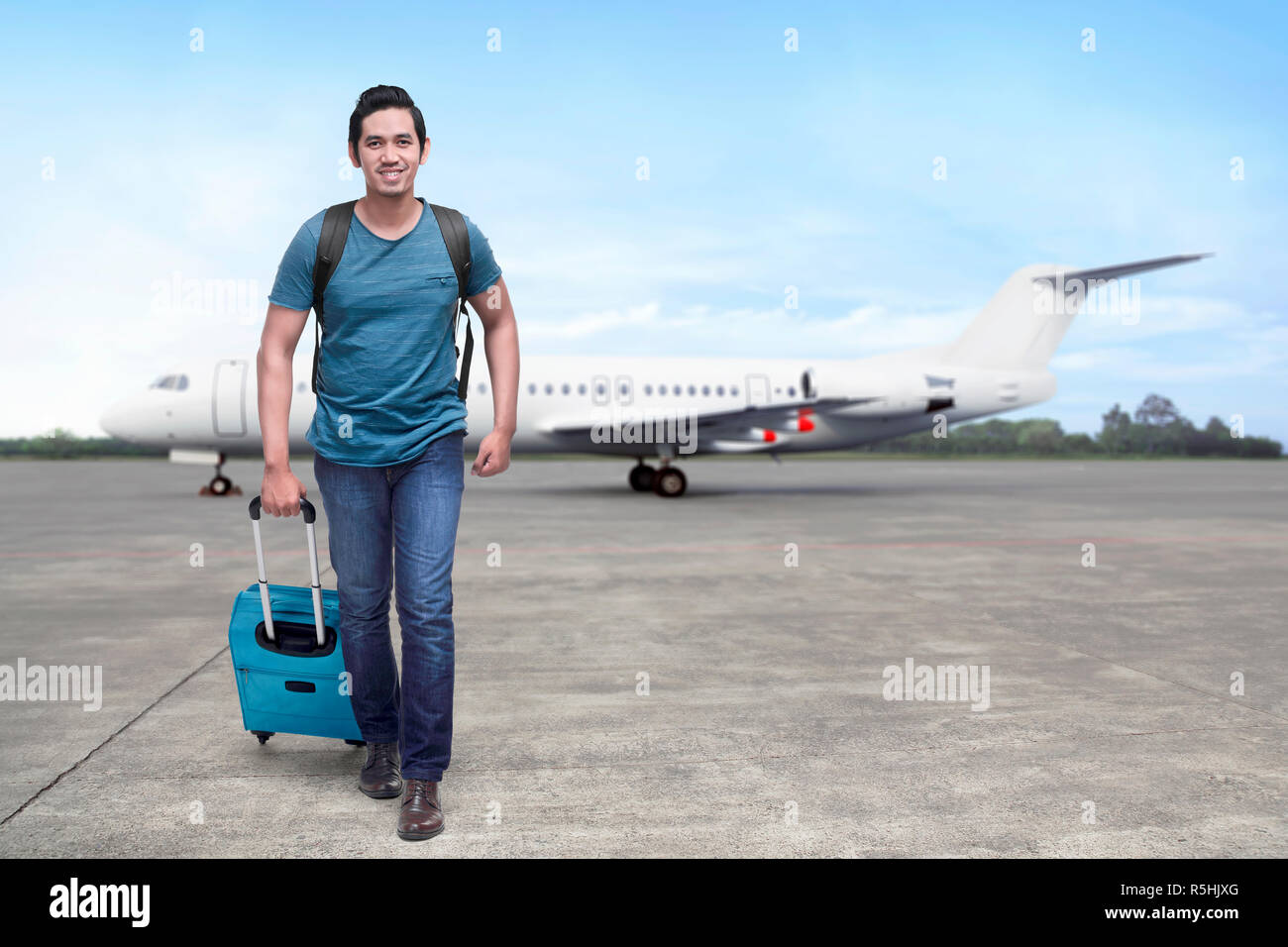 Traveler asian man get off the plane with suitcase Stock Photo - Alamy
