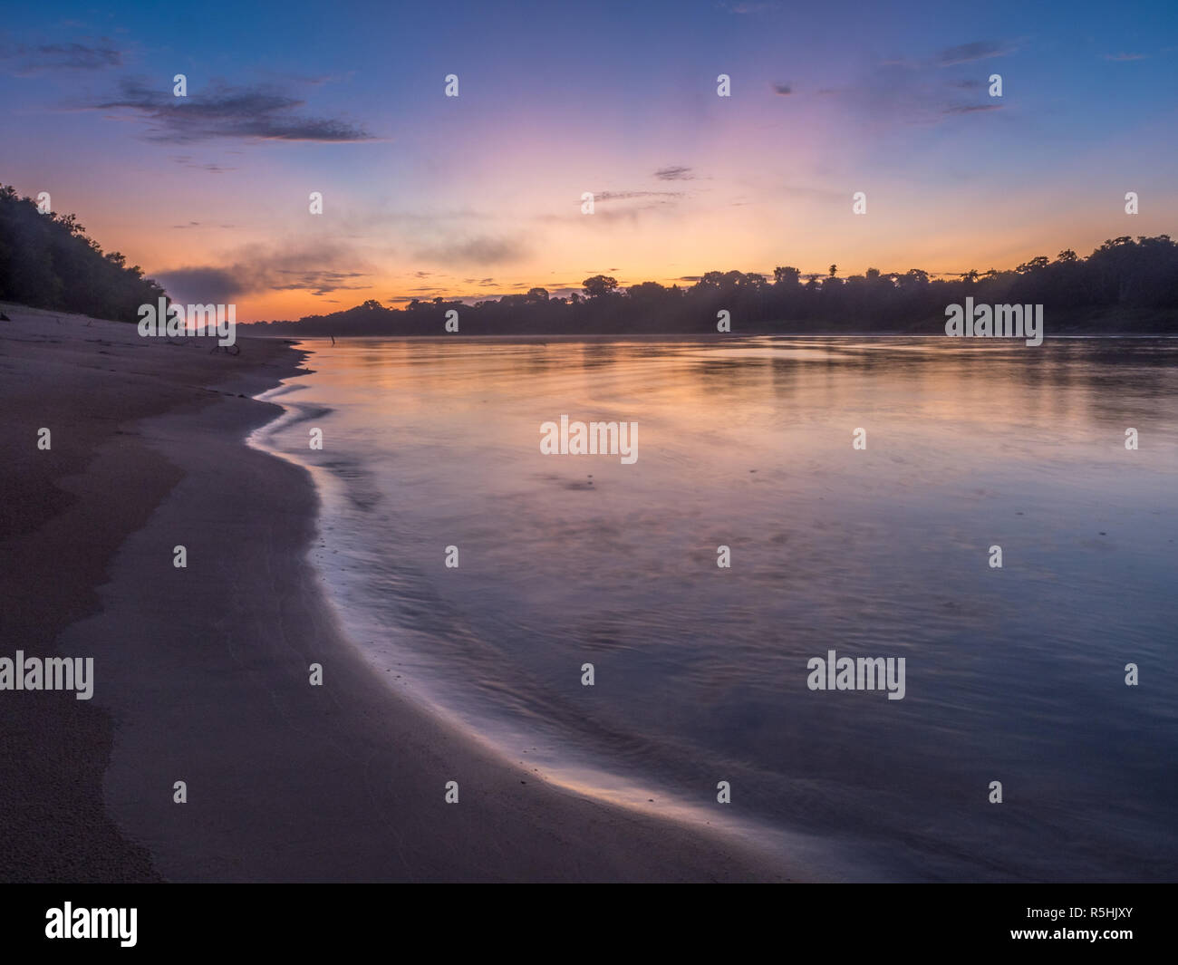 Sunrise over the Javarii river, tributary of the Amazon. Sandy beach in ...