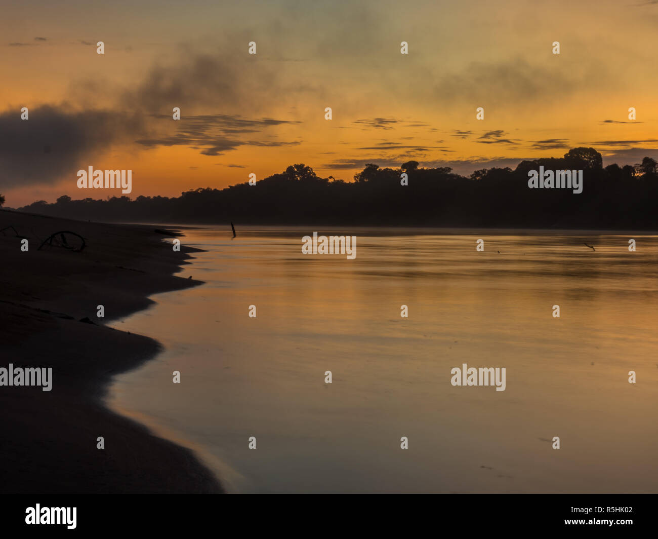 Sunrise over the Javarii river, tributary of the Amazon. Sandy beach in ...