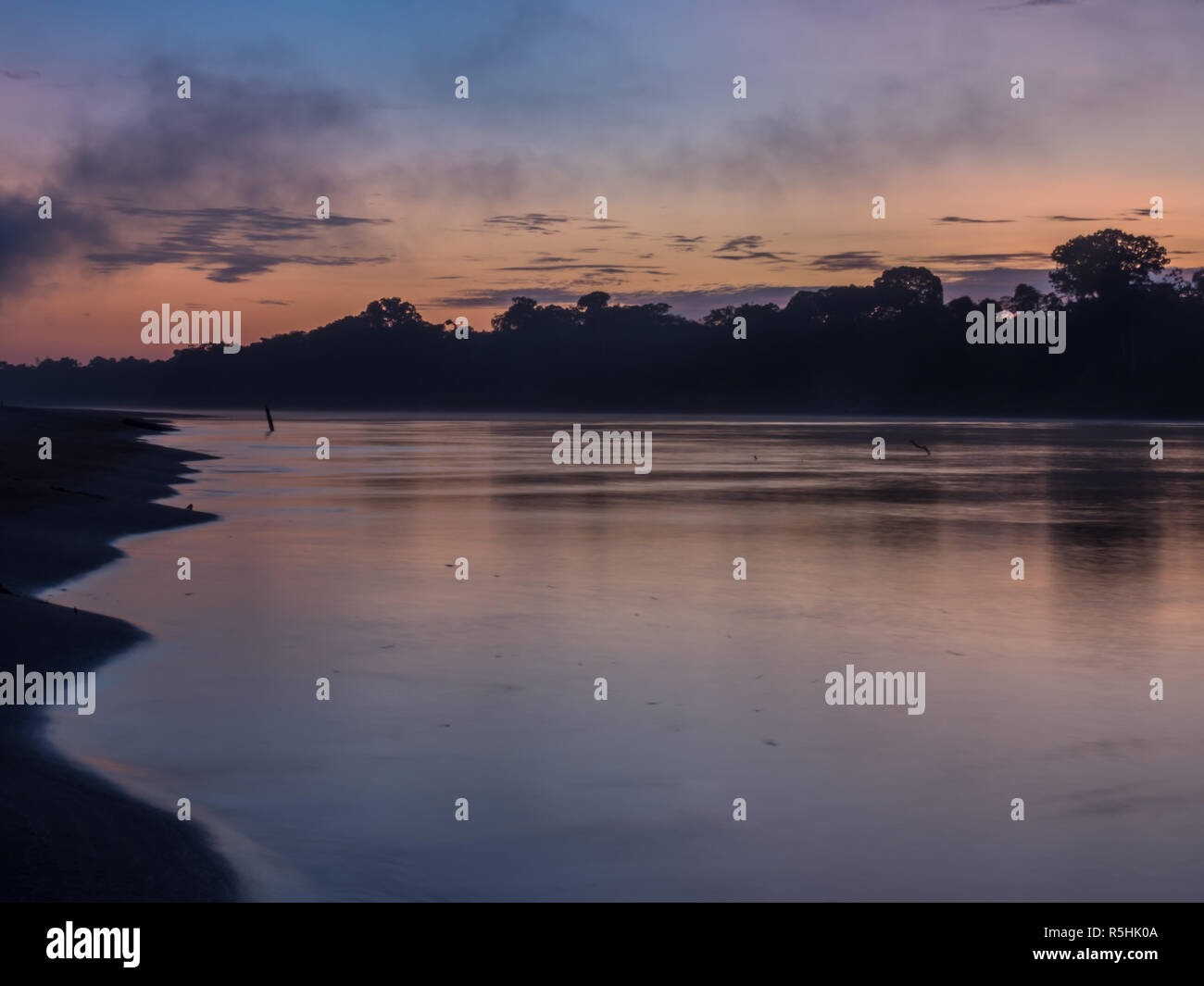 Sunrise over the Javarii river, tributary of the Amazon. Sandy beach in ...