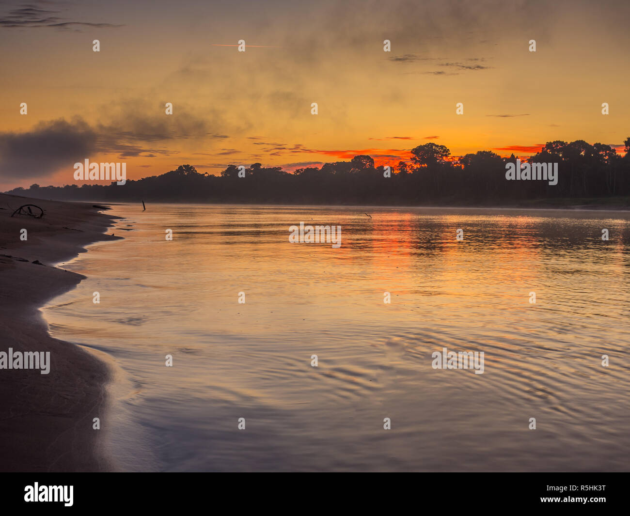 Sunrise over the Javarii river, tributary of the Amazon. Sandy beach in ...