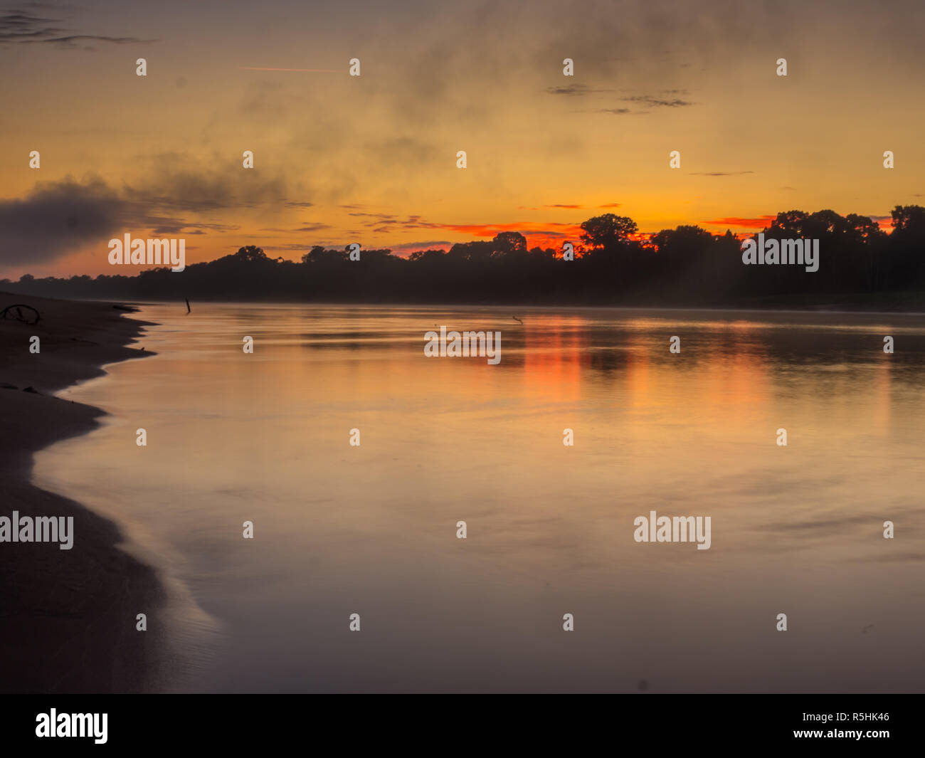 Sunrise over the Javarii river, tributary of the Amazon. Sandy beach in ...