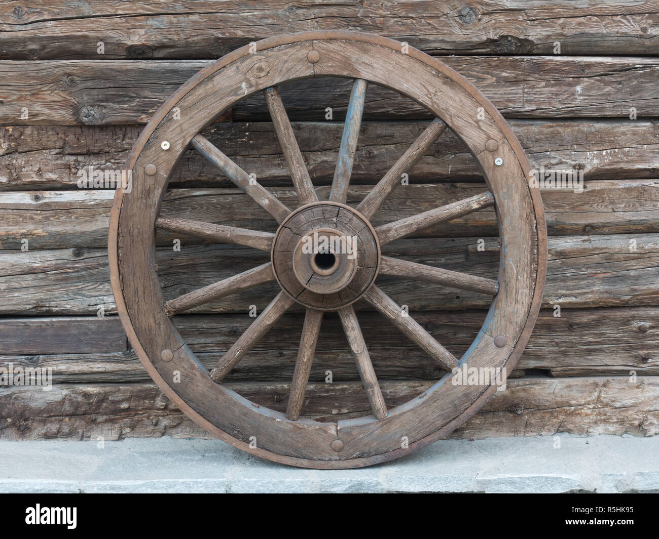 Antique wooden wheel of carriage isolated on an old wall Stock Photo ...