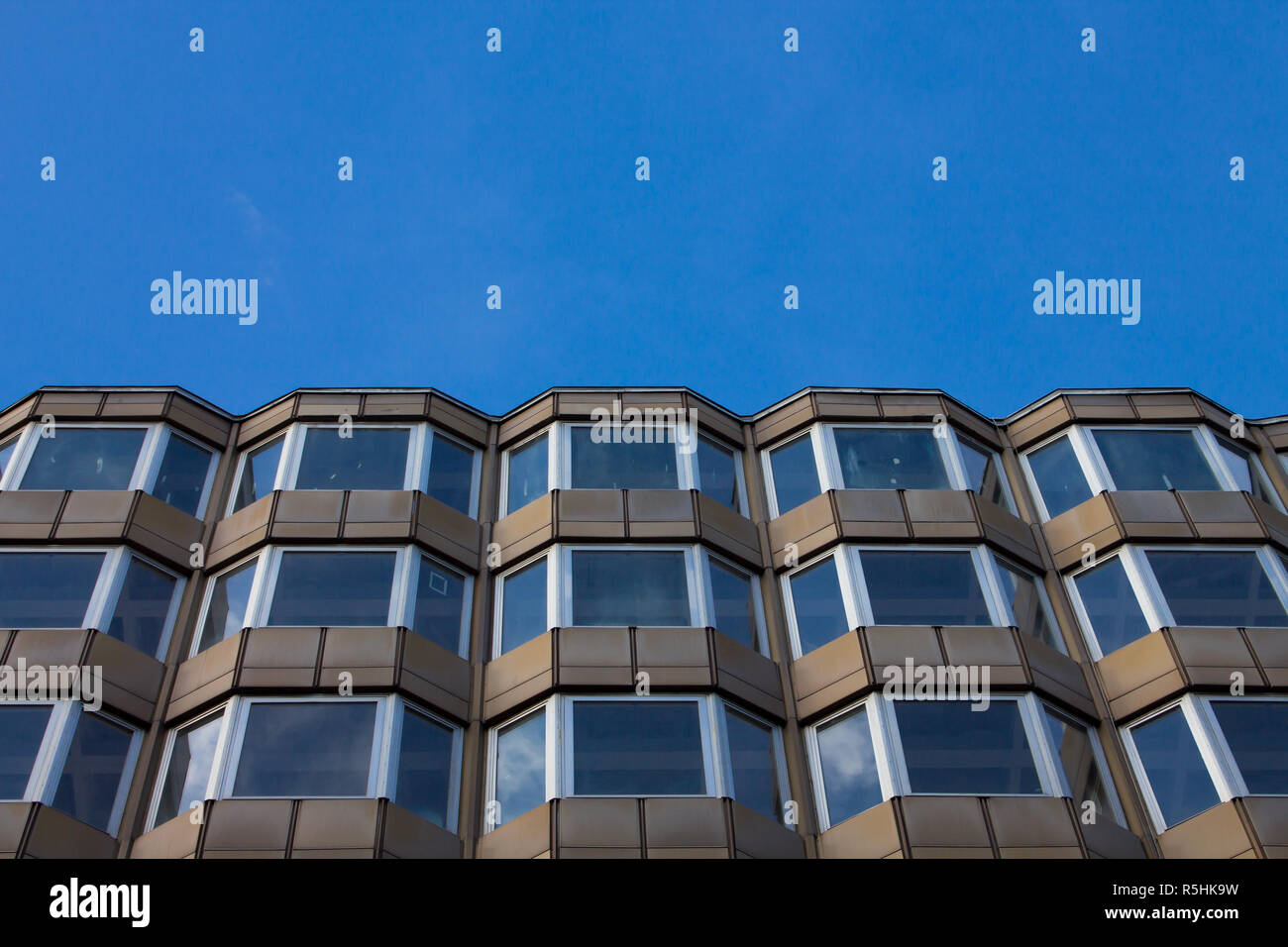 Modern architecture windows see from bottom with sky reflection ...