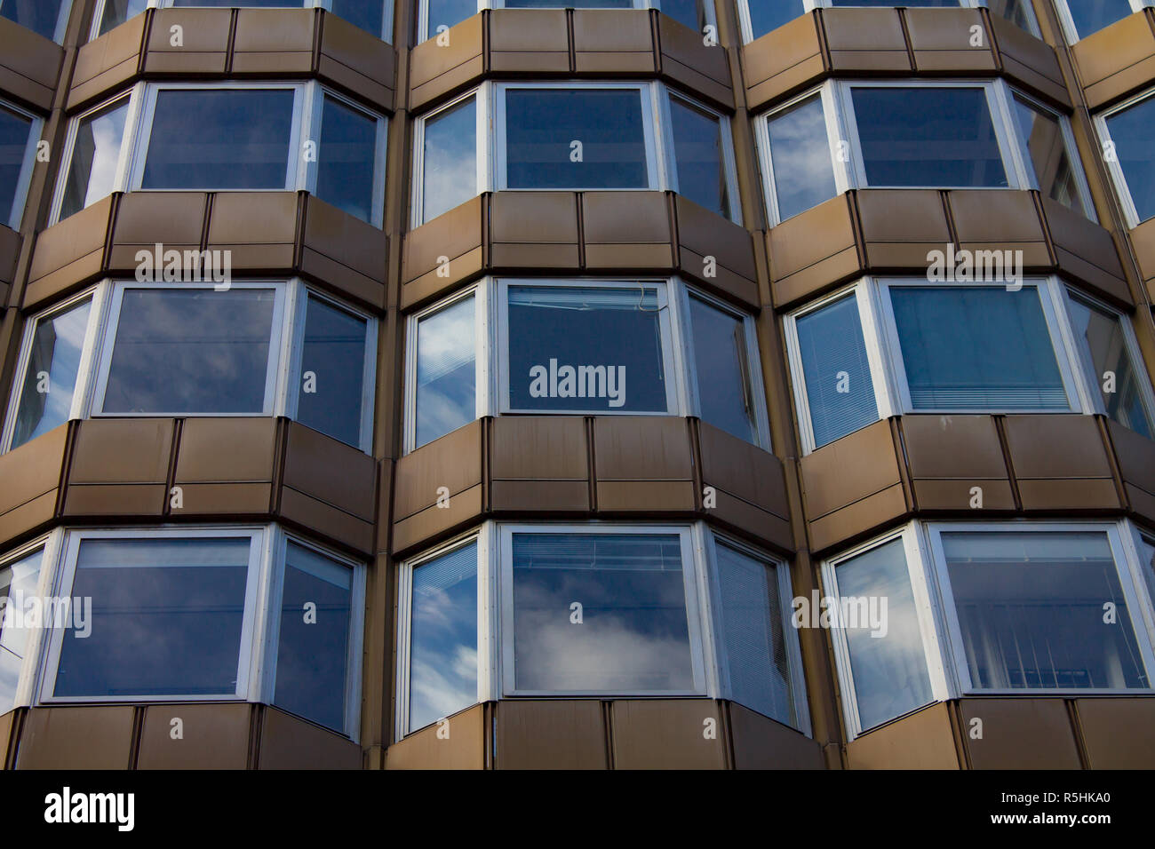 Modern architecture closeup windows see from bottom with sky reflection ...