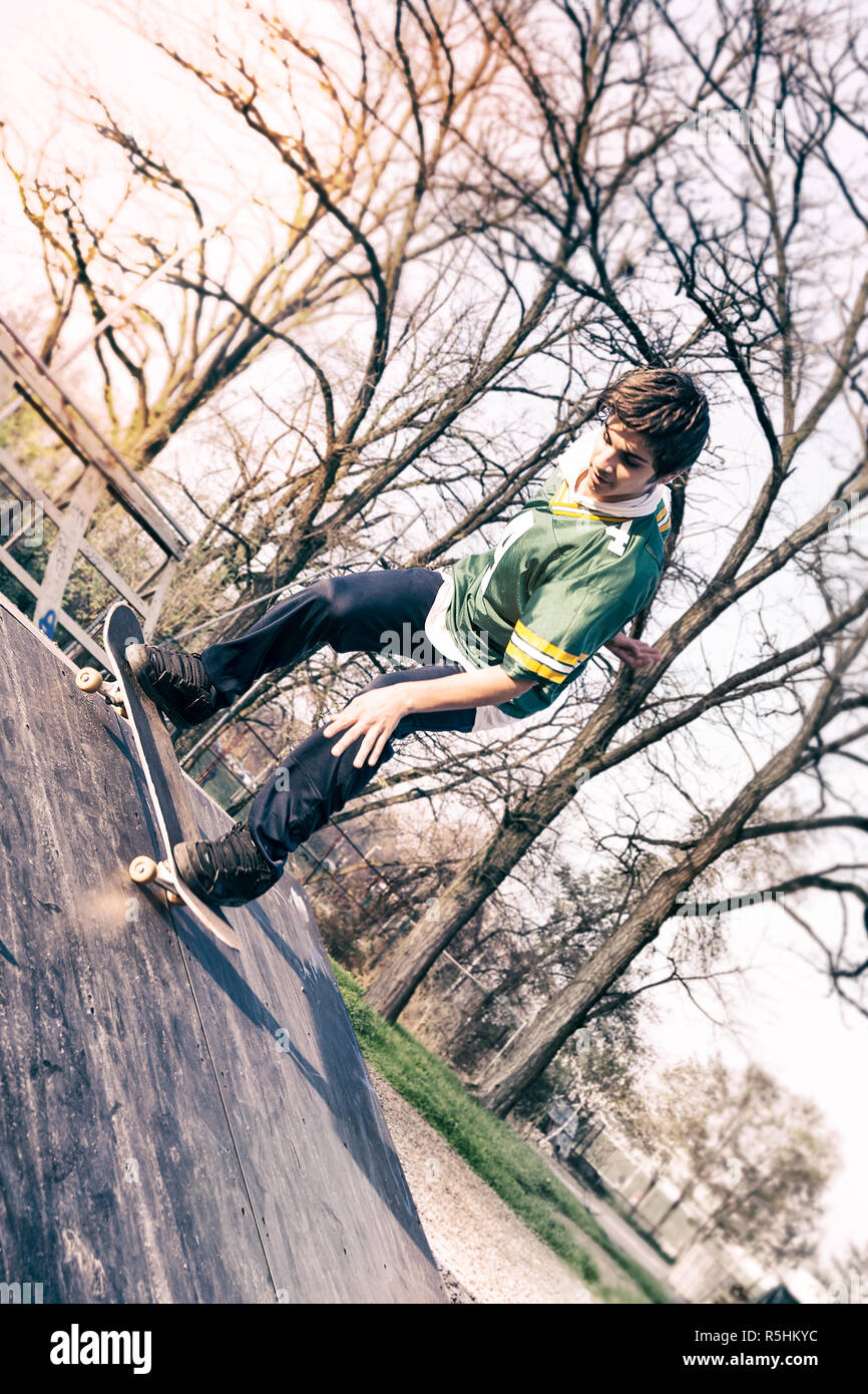 young skateboarder jumping on a ramp outdoor Stock Photo - Alamy