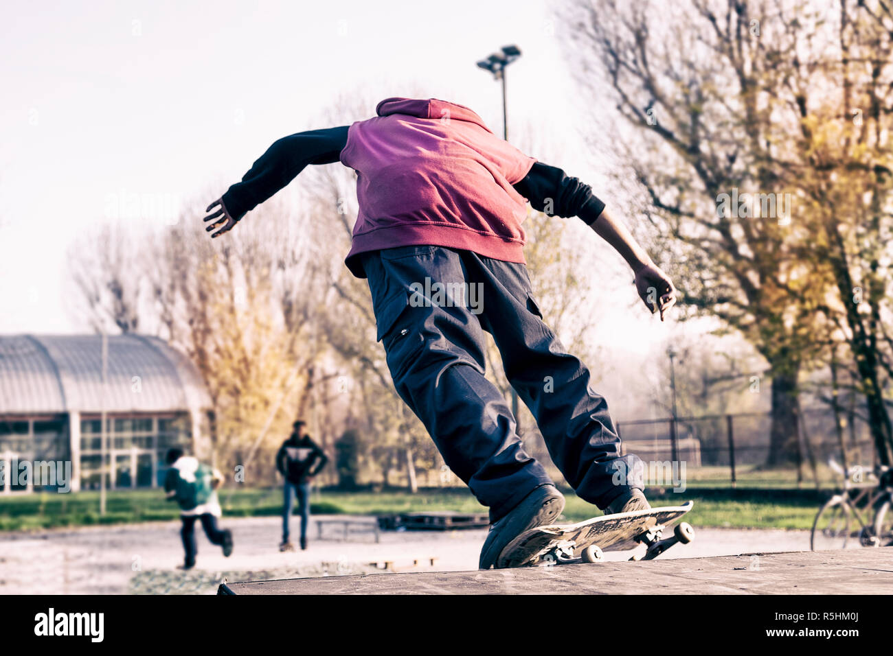 young skateboarder jumping on a ramp outdoor Stock Photo - Alamy