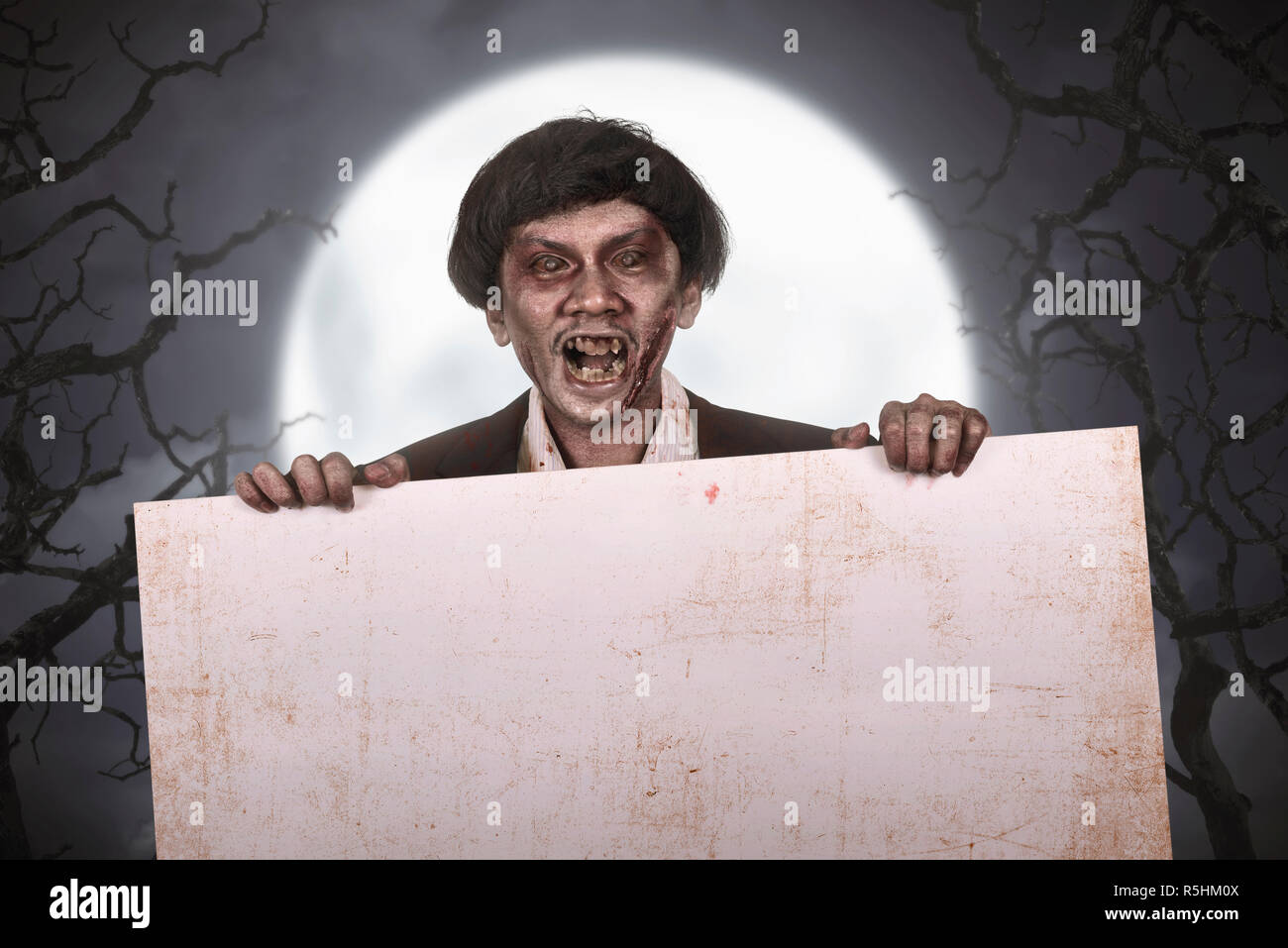 Scary asian zombie man with wounded face with empty banner Stock Photo ...