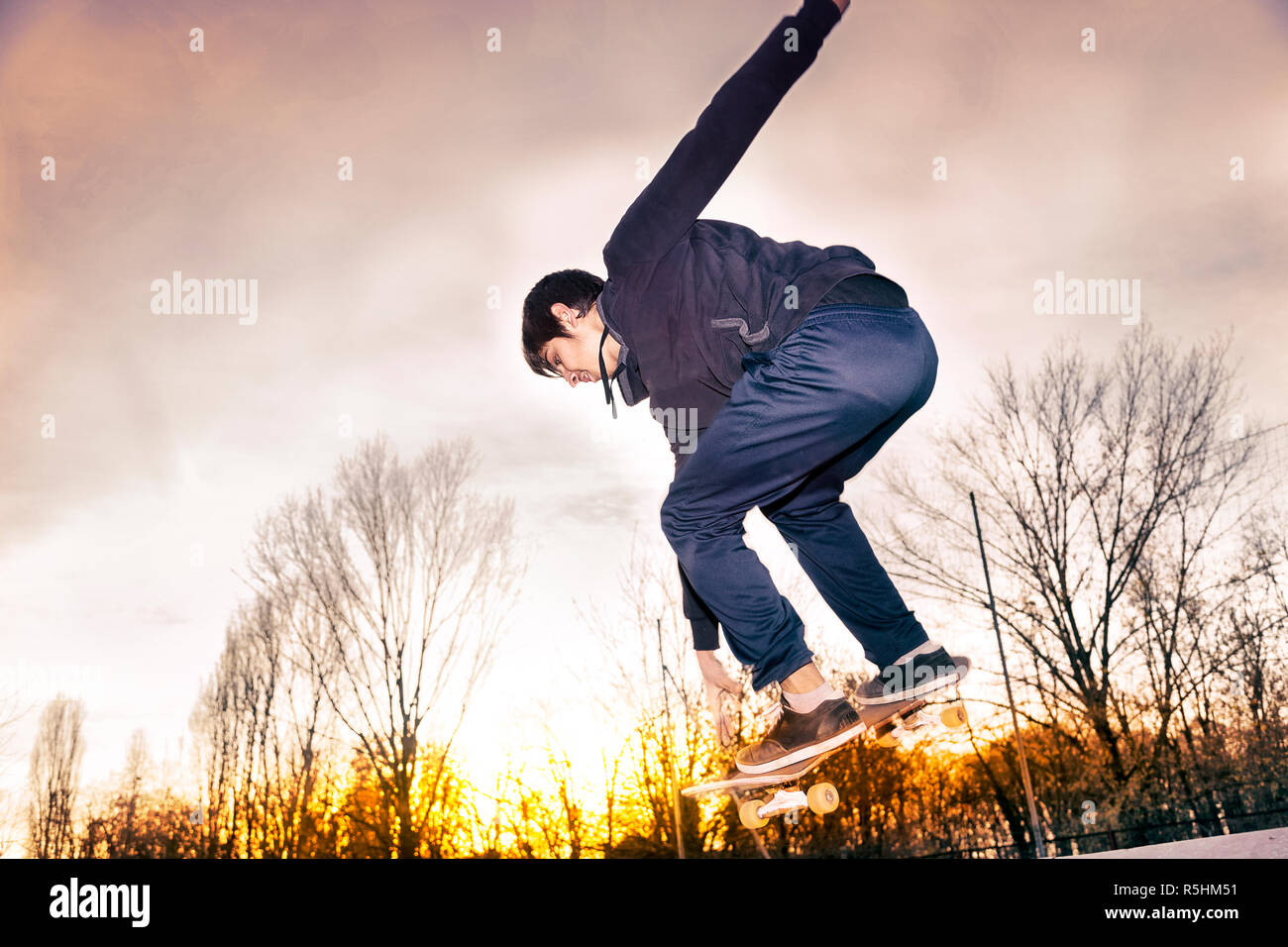 young skateboarder jumping on a ramp outdoor Stock Photo - Alamy