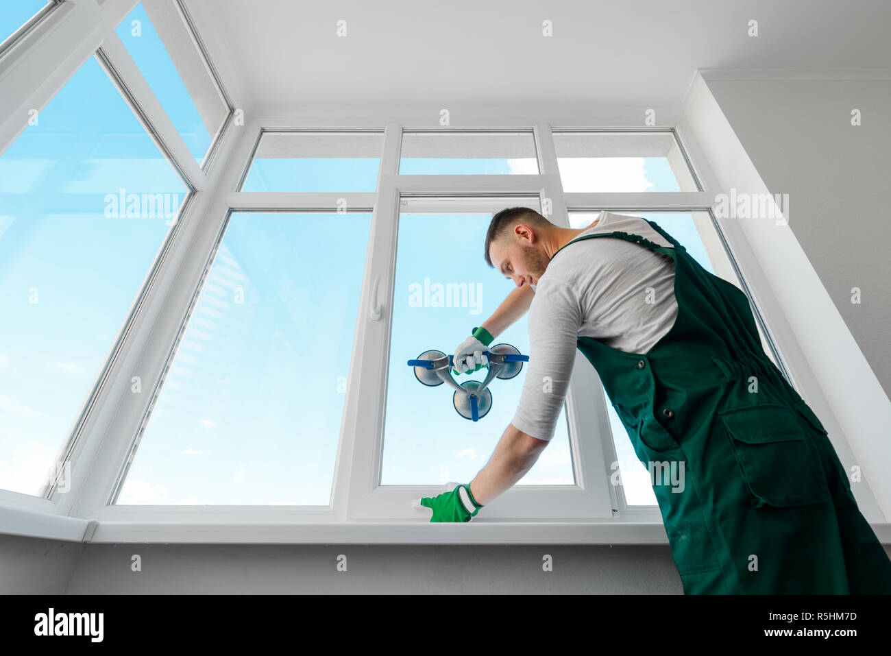 Installing a white corner window Stock Photo - Alamy
