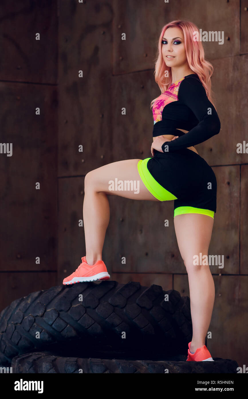 Horizontal shot of slim sporty woman has nice healthy muscular body ...