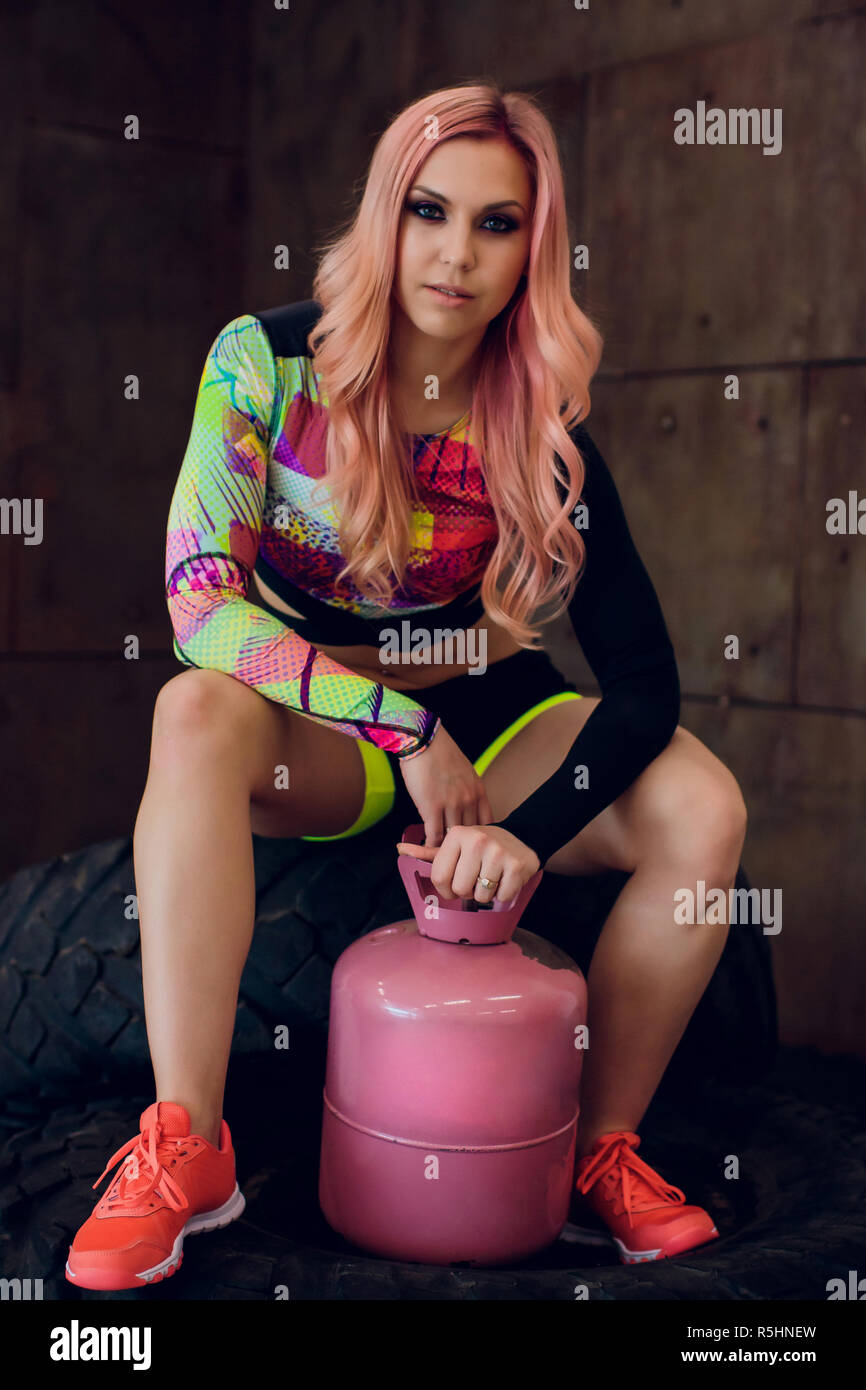 Horizontal shot of slim sporty woman has nice healthy muscular body ...