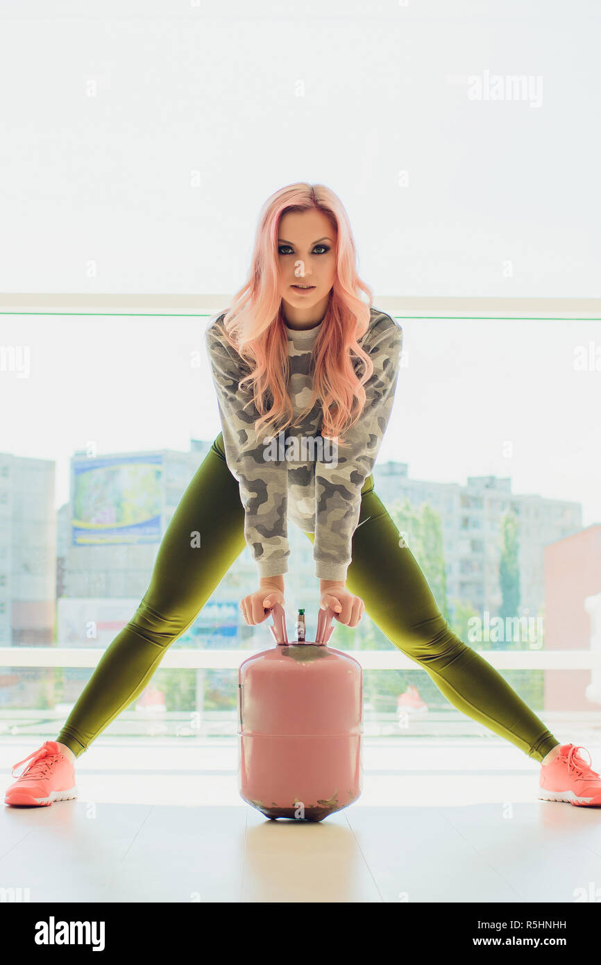 Horizontal shot of slim sporty woman has nice healthy muscular body ...